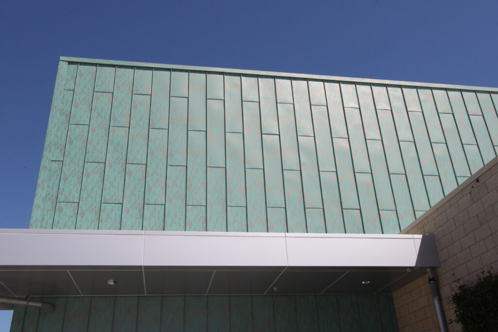 Panels are shingle-like, vertical cladding - Metal Architecture