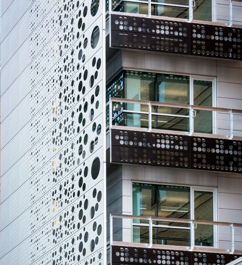 Elevator tower features perforated panels - Metal Architecture